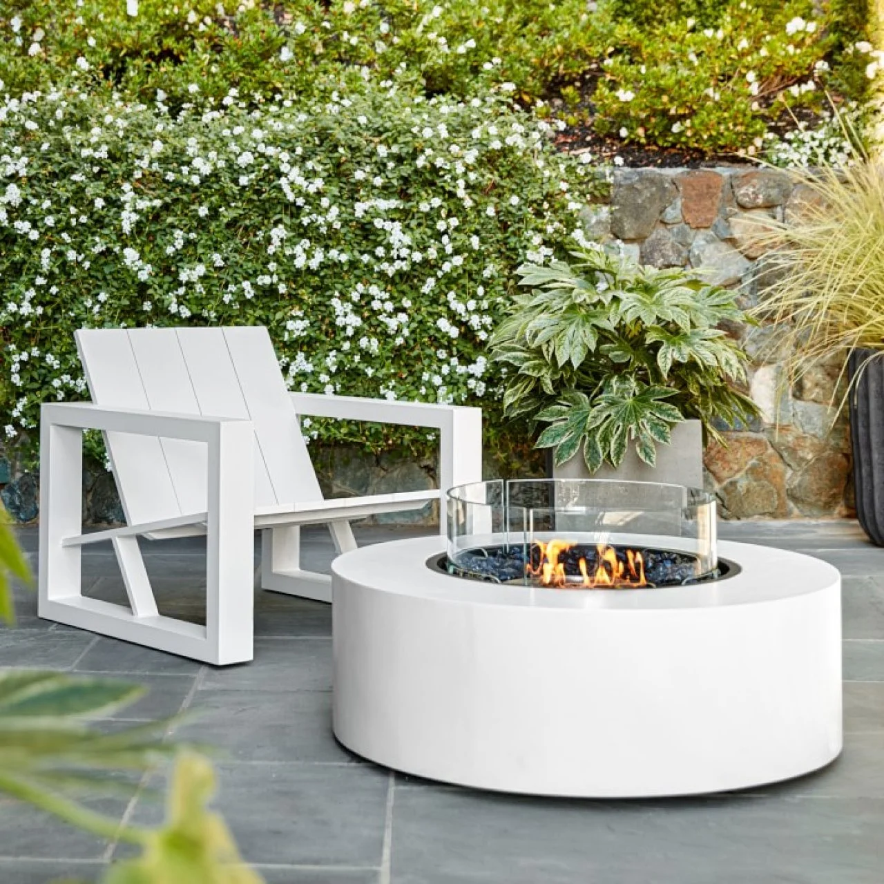 Round fire pit with propane tank inside store